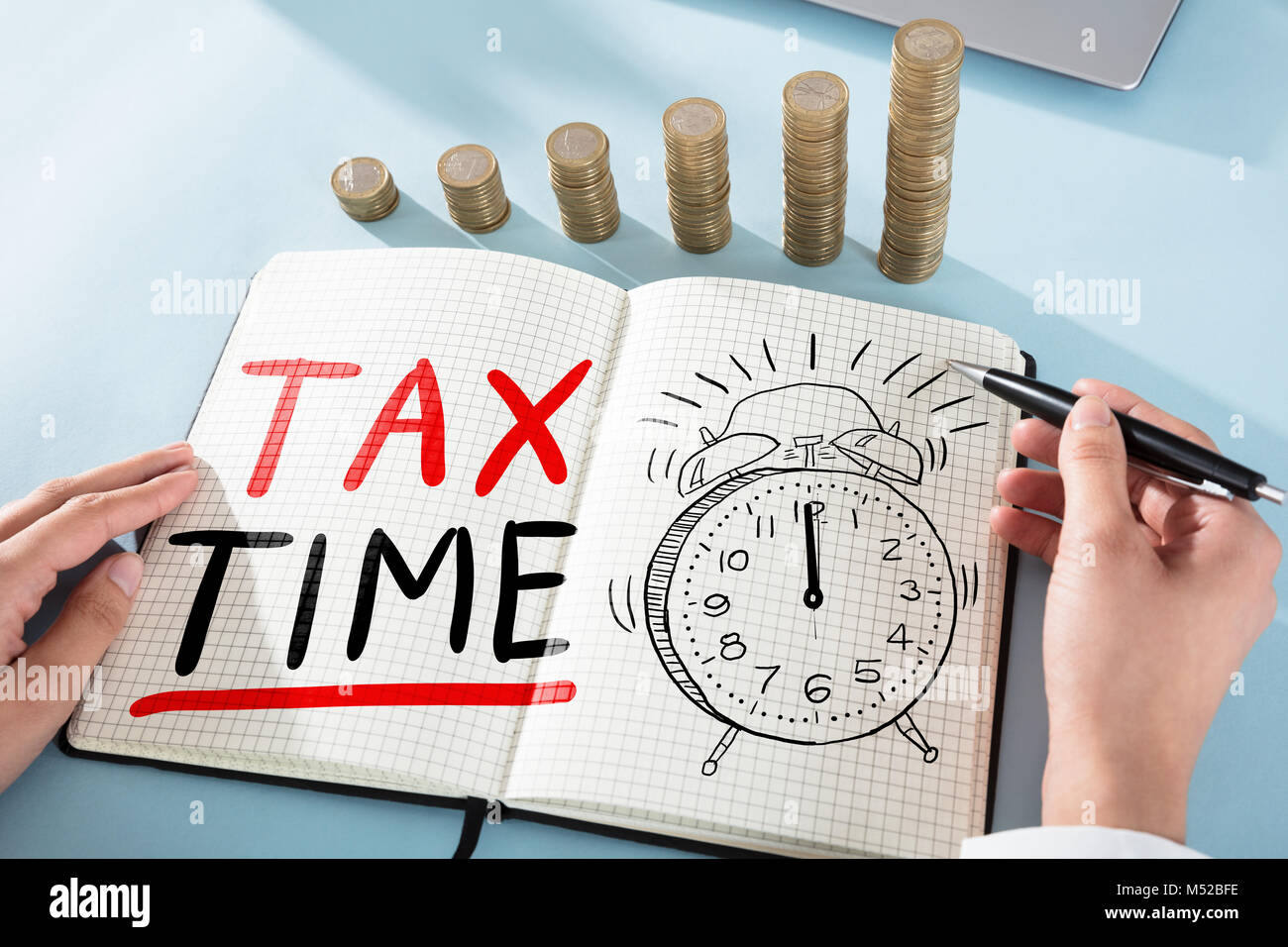 Woman Drawing Tax Time Concept In Notepad Stock Photo - Alamy