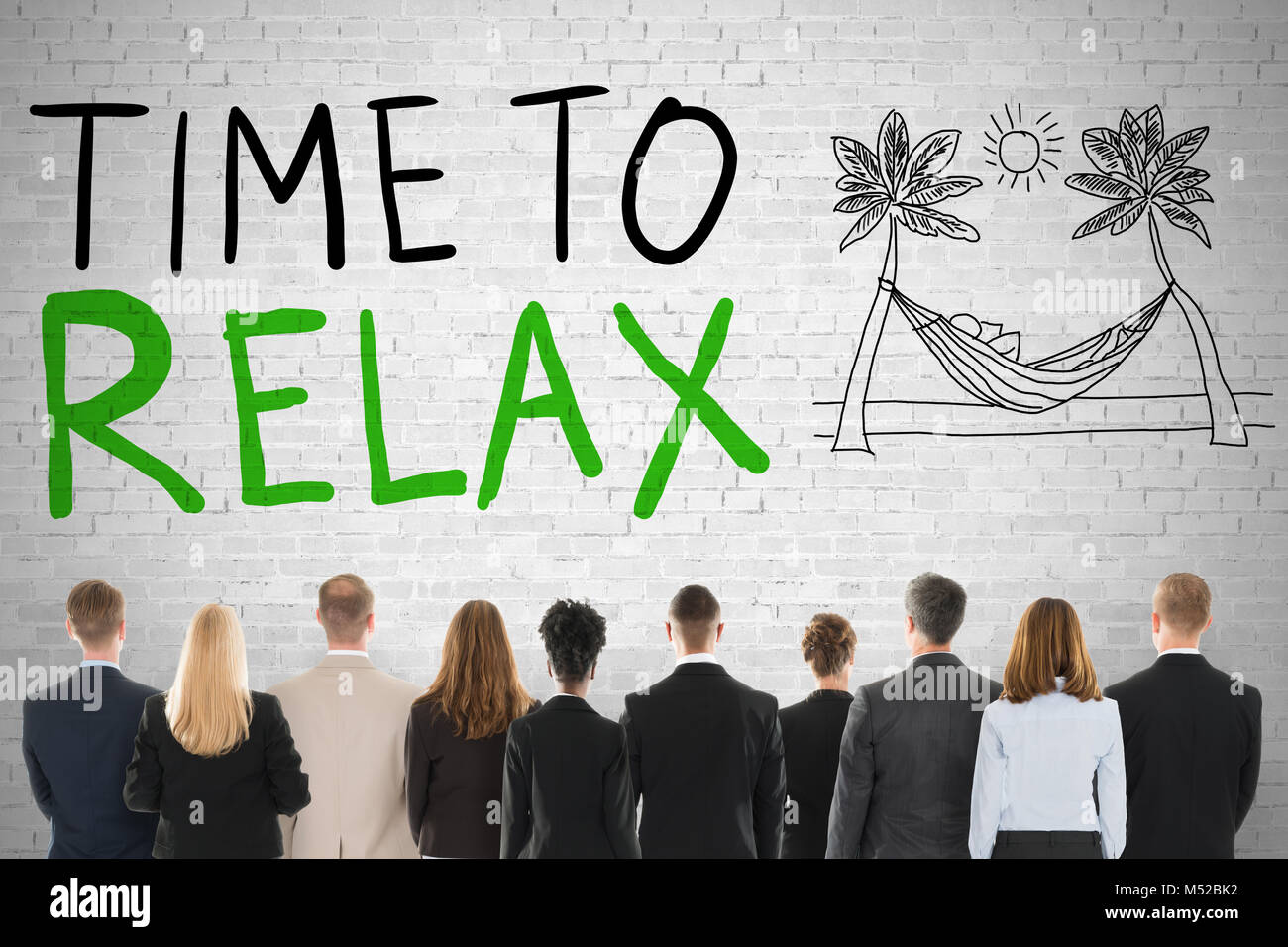 Group Of Diverse People Looking At Time To Relax Stock Photo - Alamy