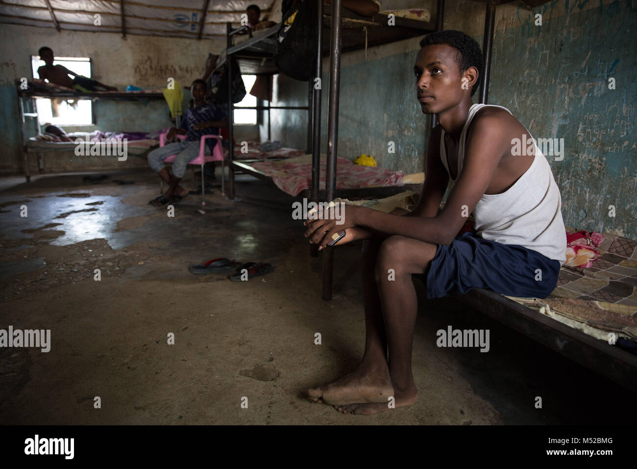A teenage boy poses in a dormitory for unaccompanied minors in Shagarab ...