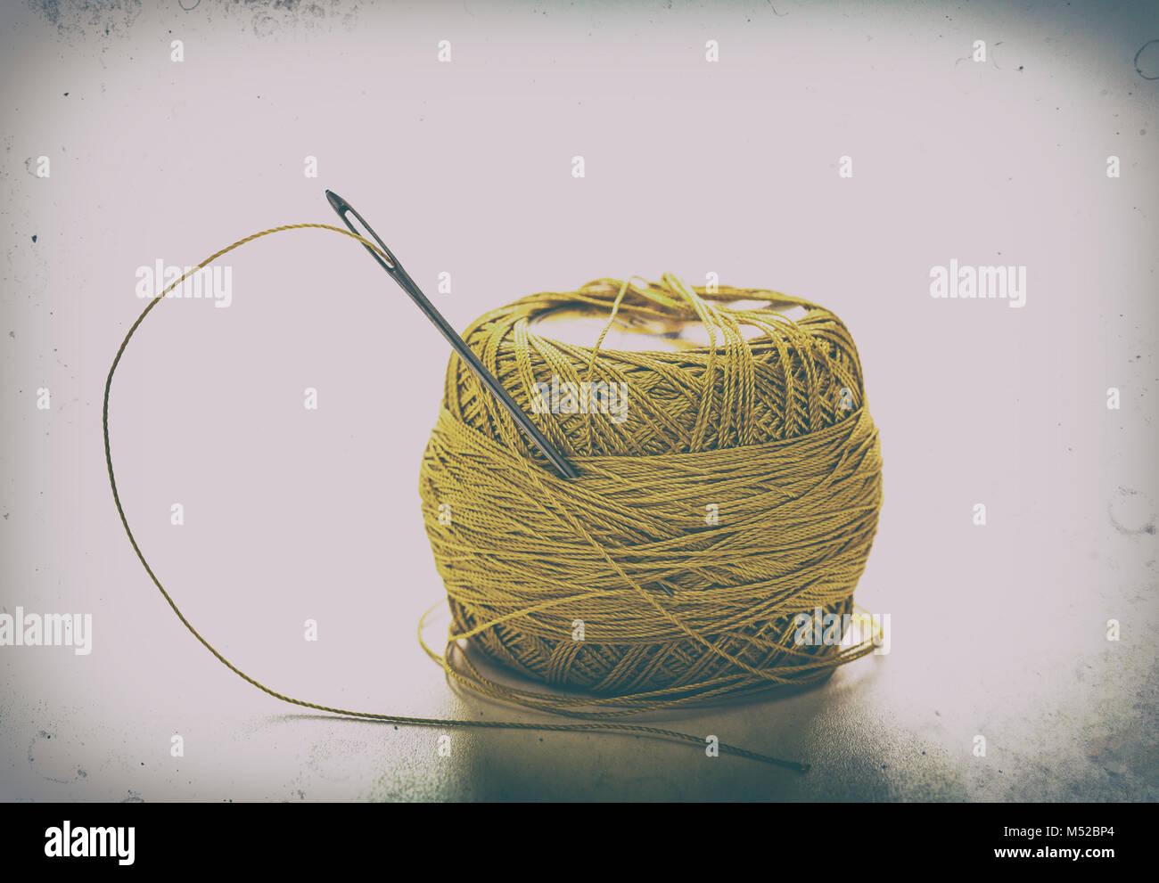 Sewing thread and needle Stock Photo - Alamy
