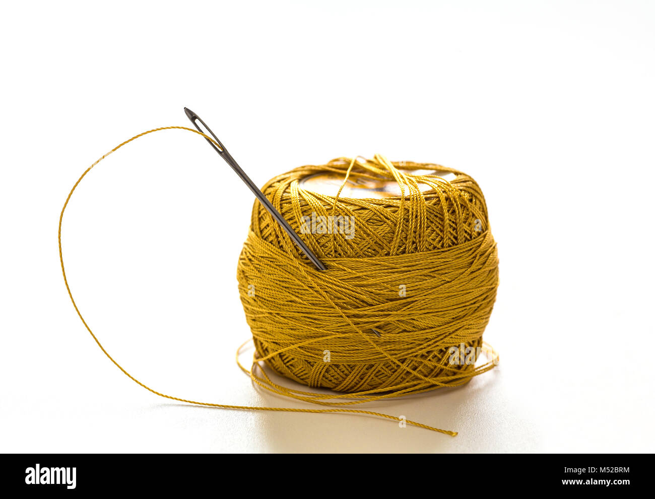 Sewing thread and needle Stock Photo - Alamy