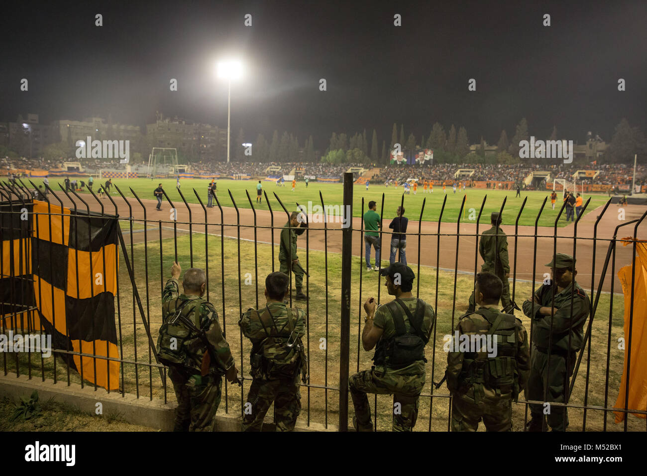 Soldiers line the pitch during the Syrian Cup final in Tishreen Stadium ...
