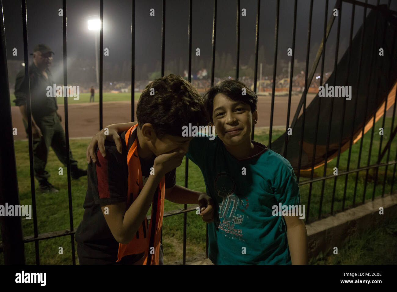 Young boys pose in front of a soldier at the Syrian Football Cup final ...