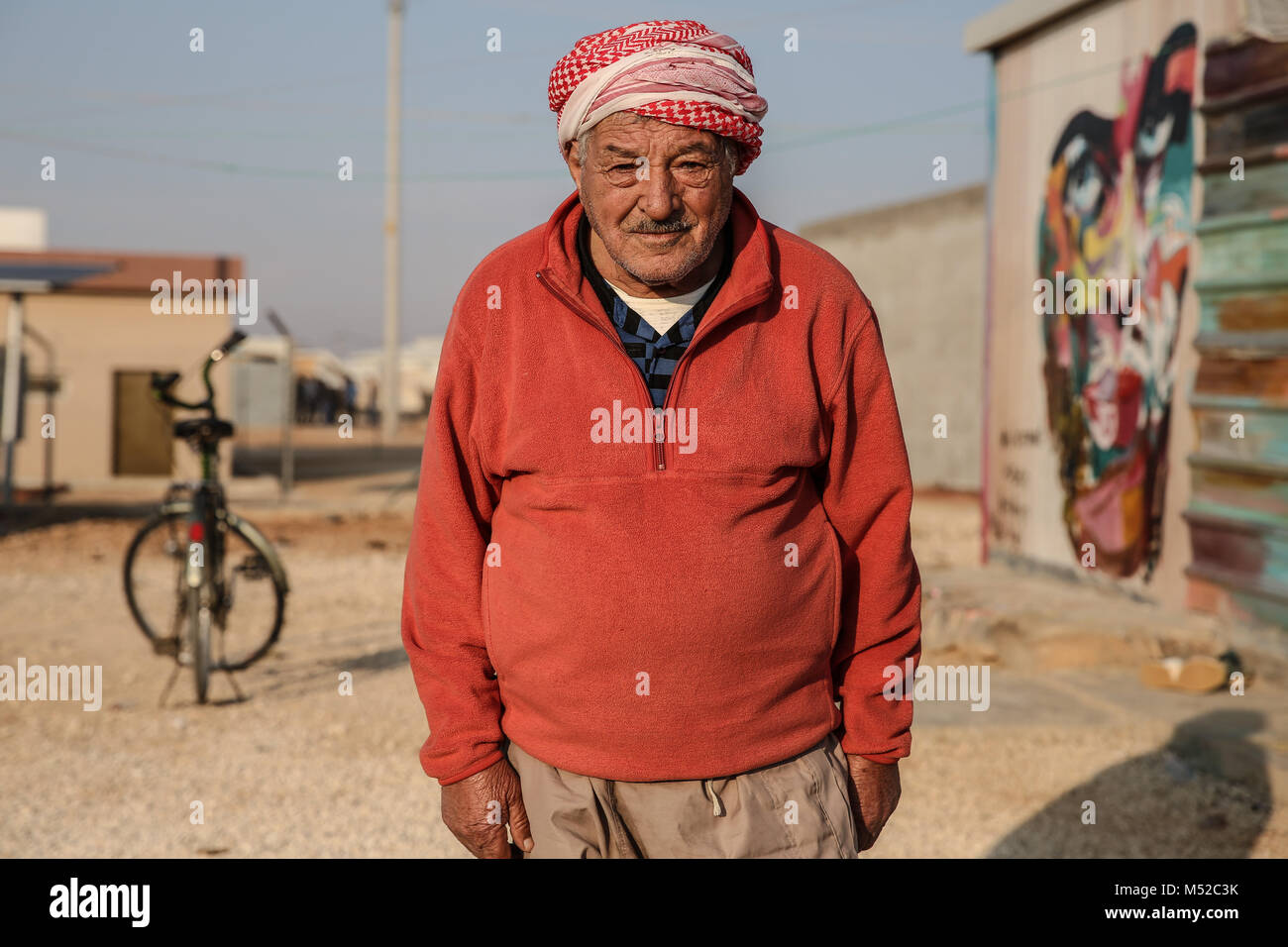 An elderly man poses in Zaatari refugee camp, the largest camp for ...