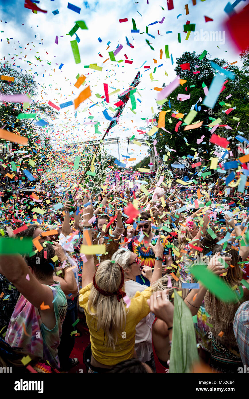 Participants seen spreading confetti on a canal boat during the parade ...