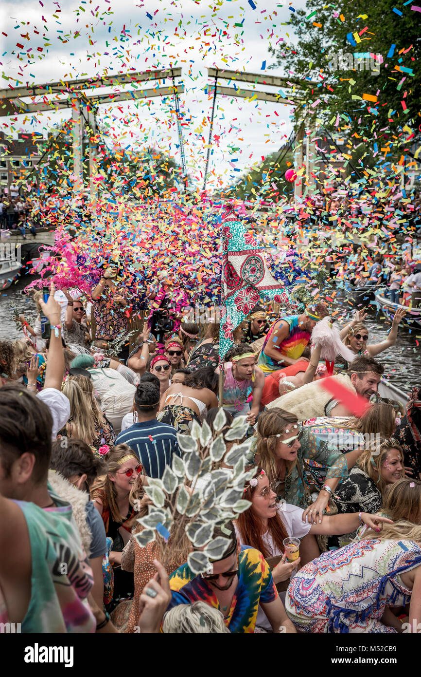 Participants seen spreading confetti on a canal boat during the parade ...