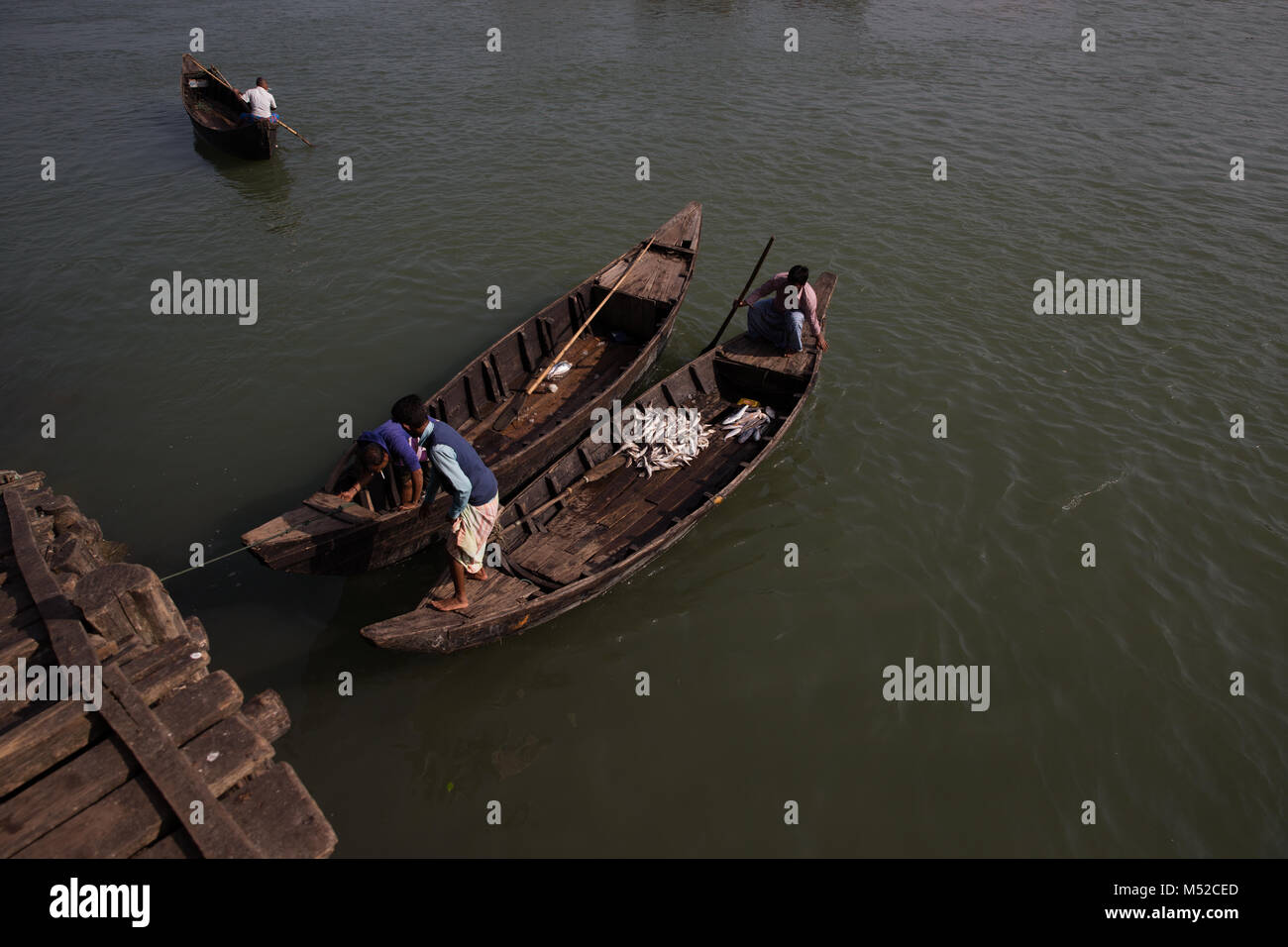 Two fishermen arrive at Cox's Bazar fish market with their catches. Cox ...