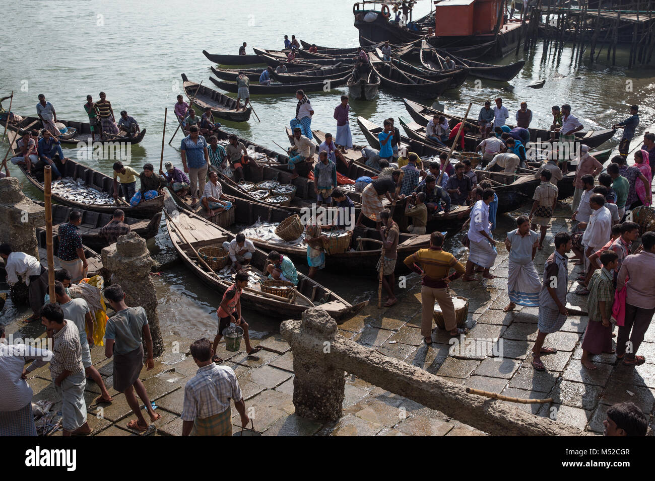 Multitudes of fishermen and boats gather at Cox's Bazar fish market ...