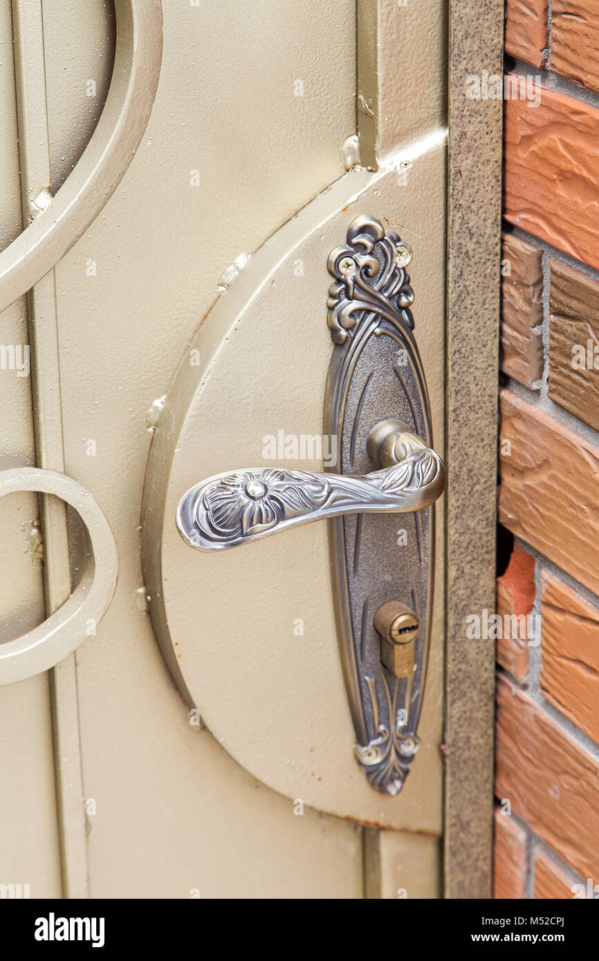 on a metal door Forged door handle with a modern lock Stock Photo - Alamy