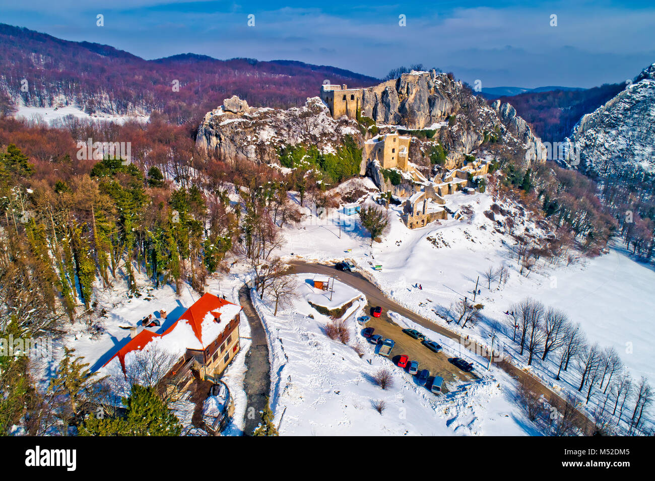 Kalnik mountain winter aerial view, fortress on cliff and lodge under ...