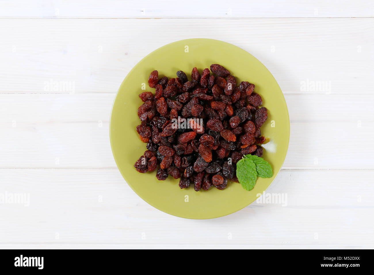 plate of sweet raisins on white background Stock Photo - Alamy