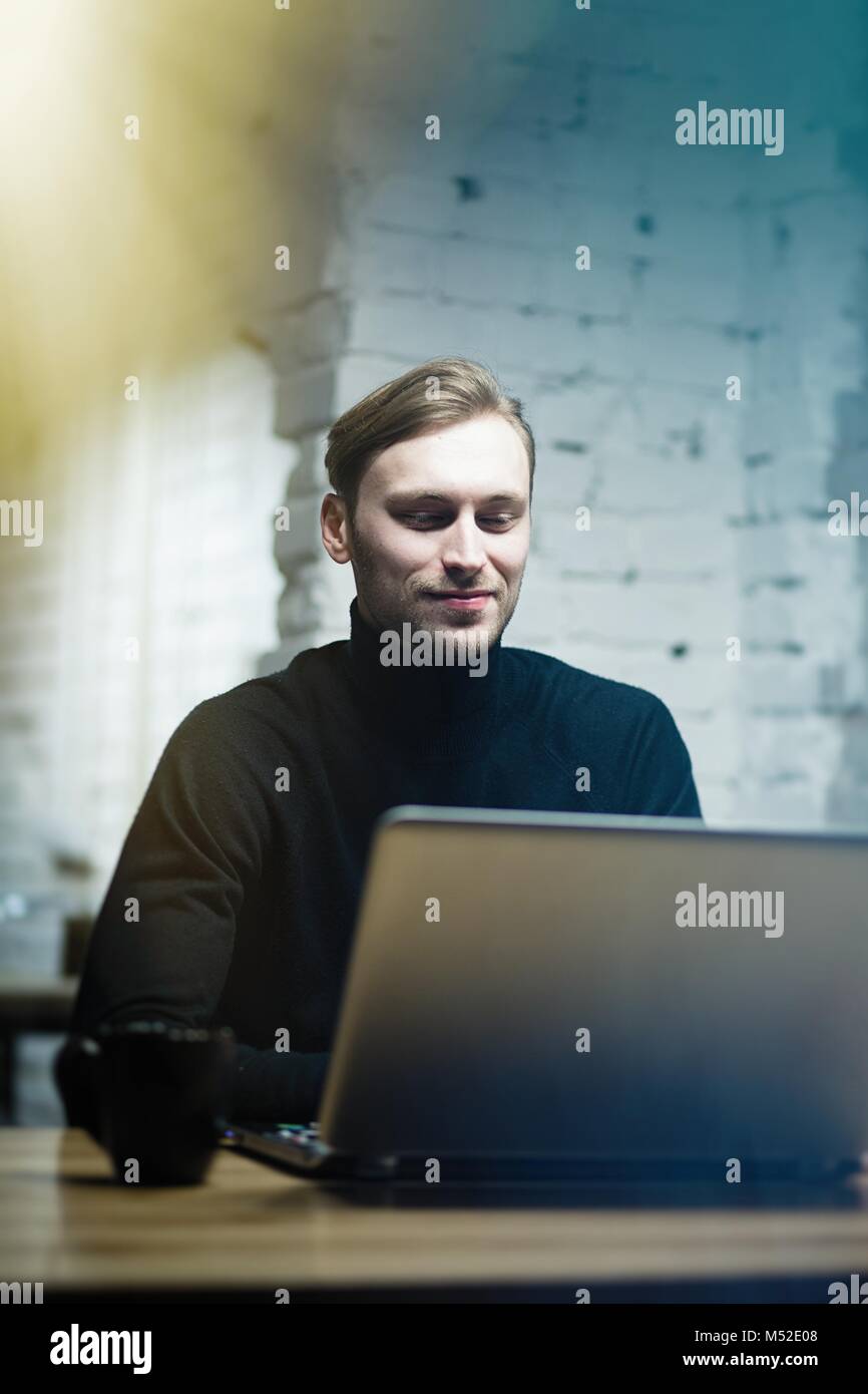 Young man with a laptop Stock Photo - Alamy