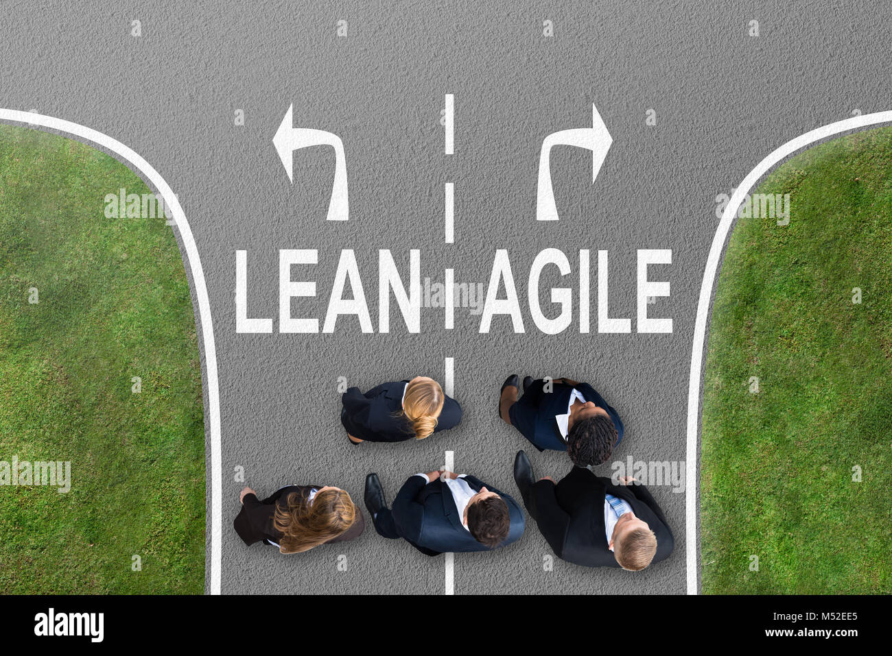 High Angle View Of Businesspeople Standing Near Arrows Showing Lean And ...