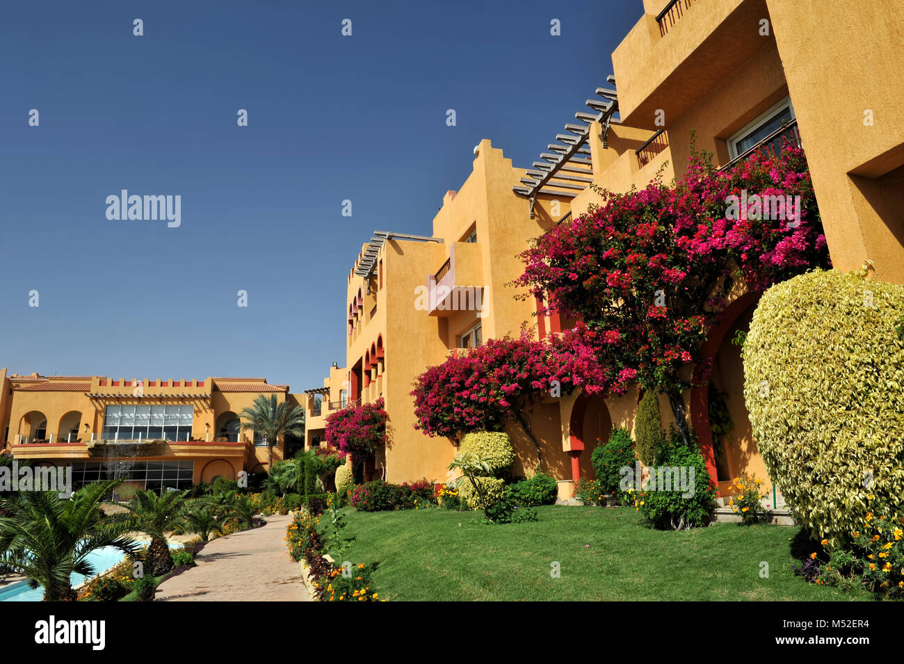 Beautiful garden at hotel resort and building in traditional arabic ...