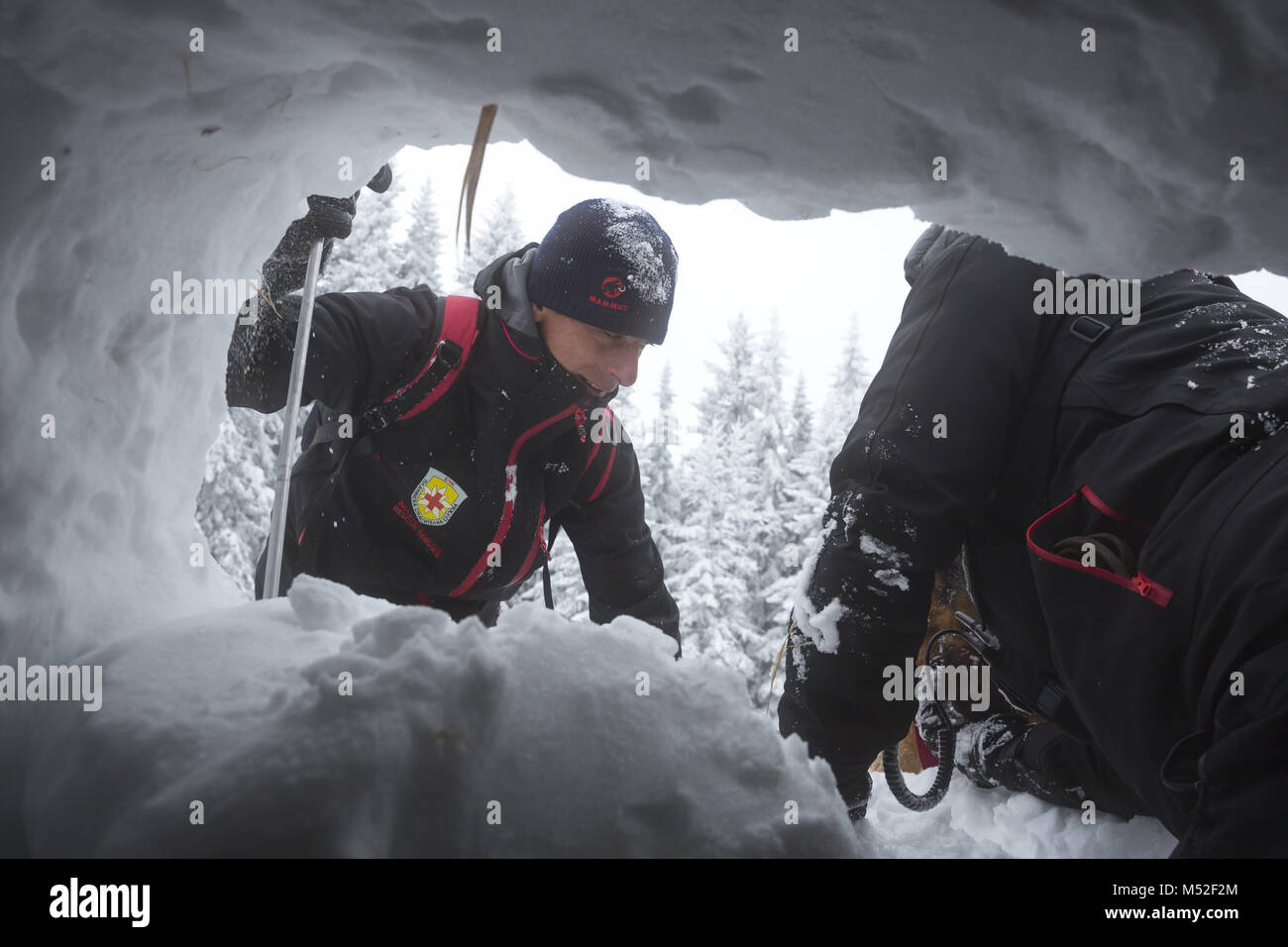 Red Cross rescuers through snow hole Stock Photo - Alamy