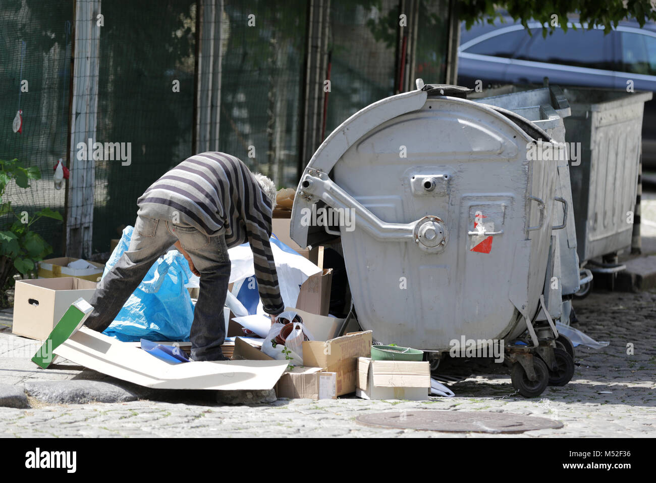 Poor homeless man collecting paper Stock Photo - Alamy