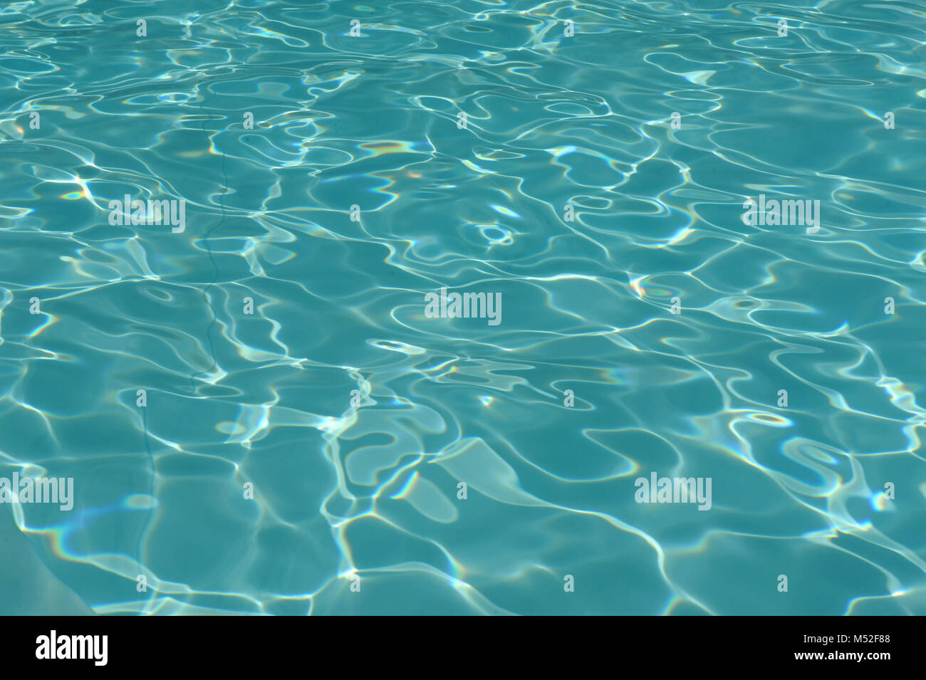Ripple water surface and sun reflection in swimming pool Stock Photo ...