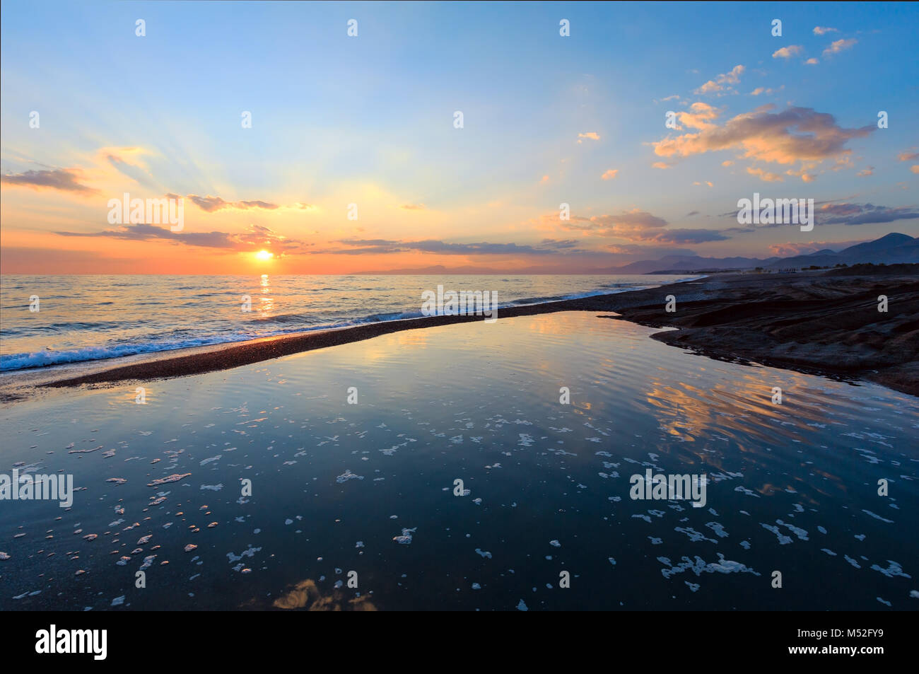 Sunset on sea beach Stock Photo - Alamy
