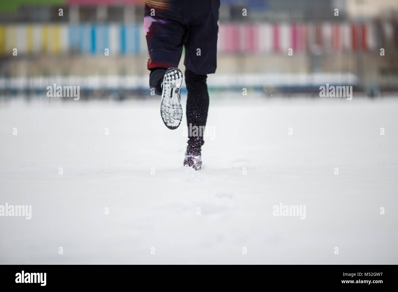 Image from back of running sportsman in stadium Stock Photo - Alamy