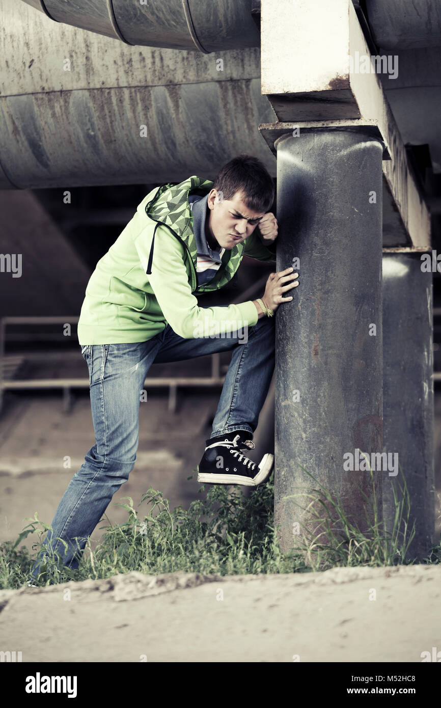 Crazy young man under pipeline Stock Photo - Alamy