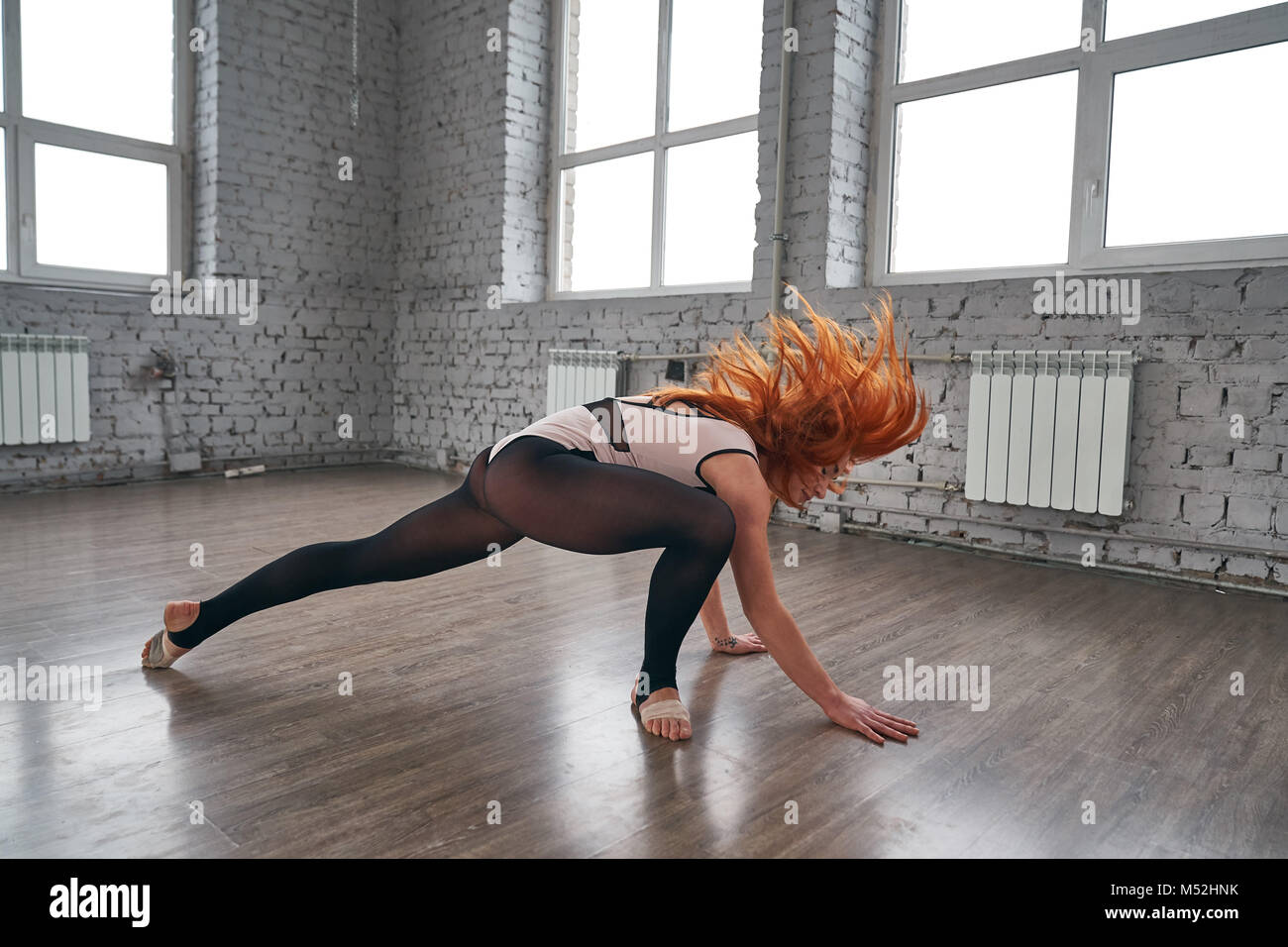 Young beautiful dancer posing on a studio background Stock Photo - Alamy