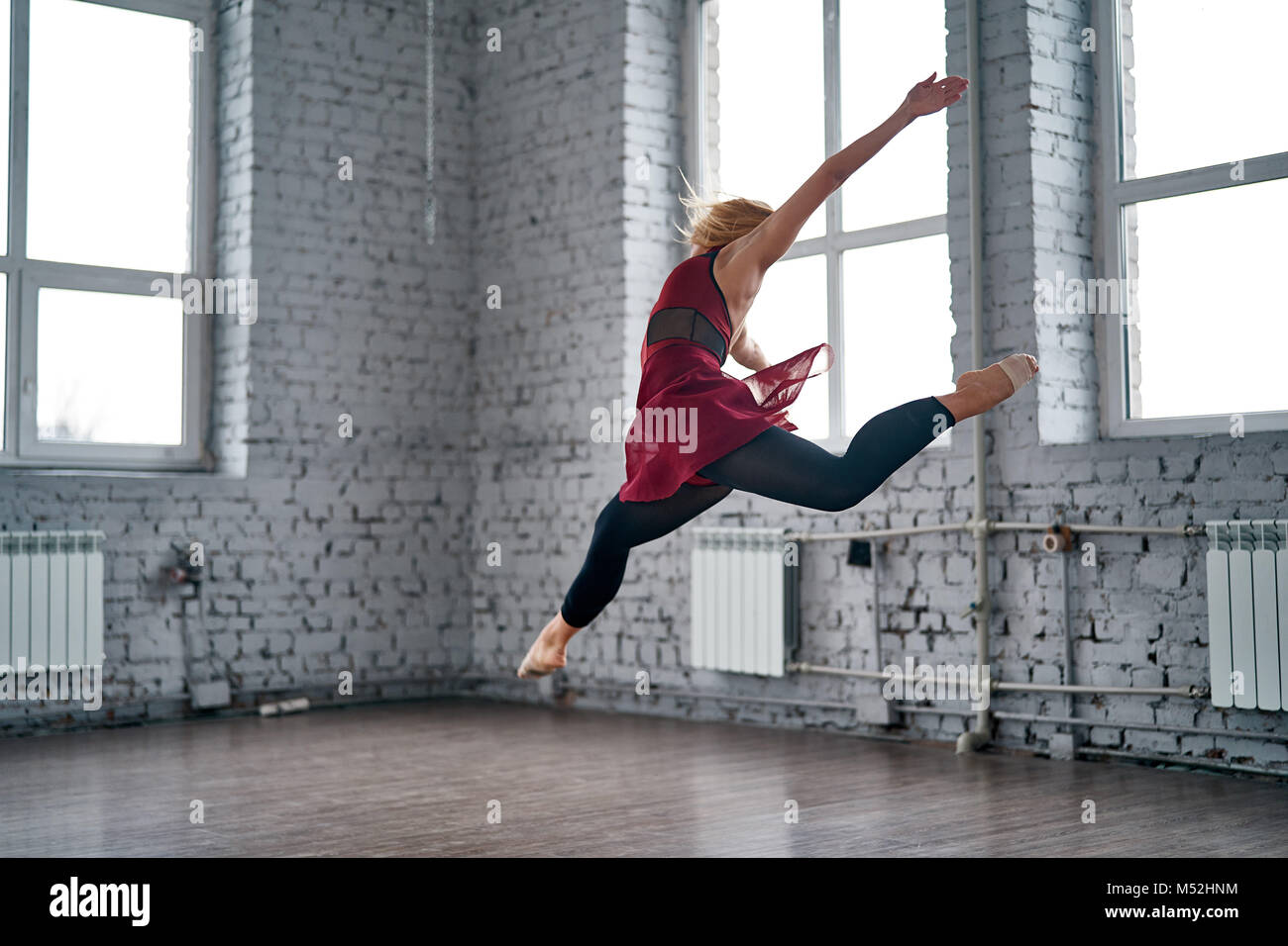 Young female dancer jumping and dancing in the gym Stock Photo - Alamy