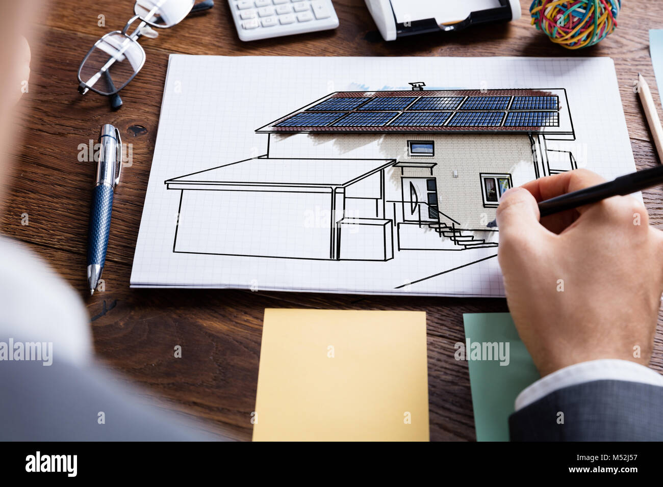 View Of A Businessperson's Hand Drawing Real Estate On Desk Stock Photo ...