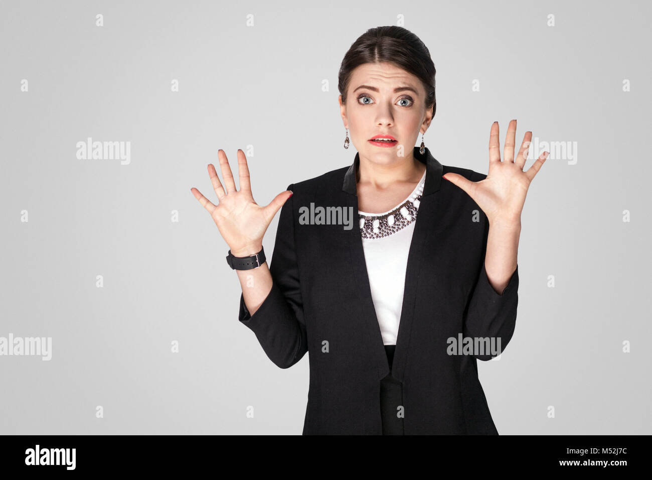 Worry nervous woman afraid and looking at camera. Studio shot, indoor ...