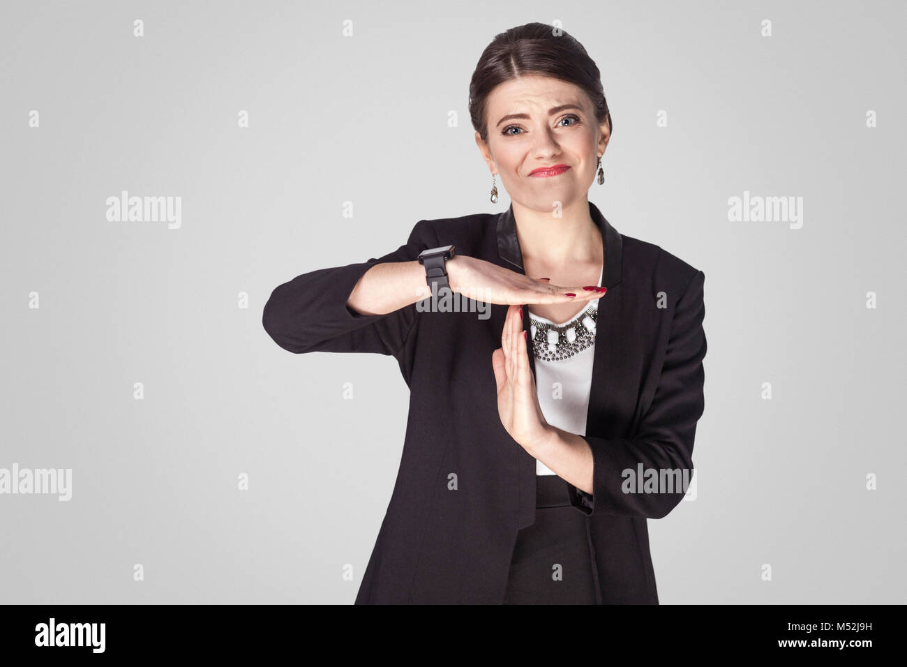 Need pause. Businesswoman showing time out sign. Studio shot, indoor ...