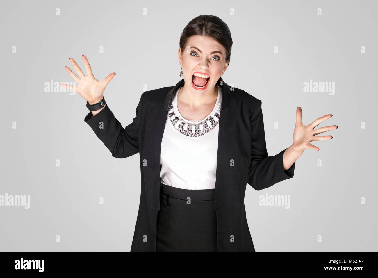Angry woman scream and shout. Studio shot, indoor. Isolated on grey ...
