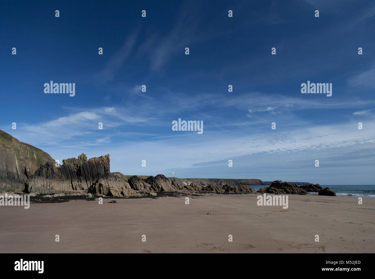 Wales landscape ocean rocky beach cloudy blue sky wide angle shot Stock ...