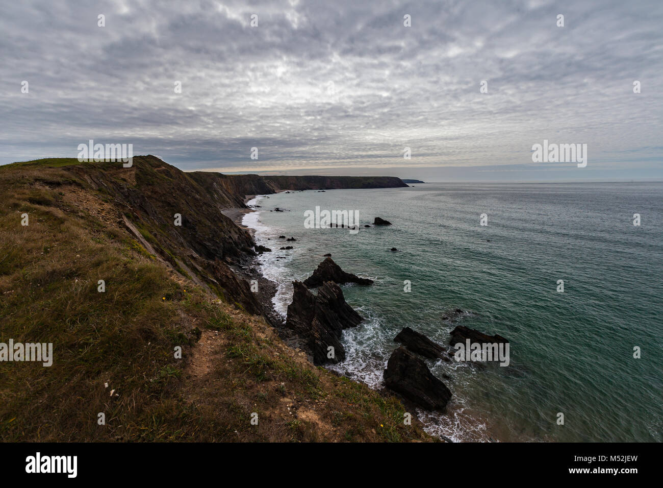 Wales landscape ocean rocky beach cloudy blue sky wide angle shot Stock ...