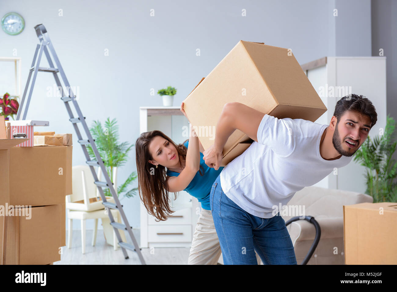 Young family unpacking at new house with boxes Stock Photo - Alamy
