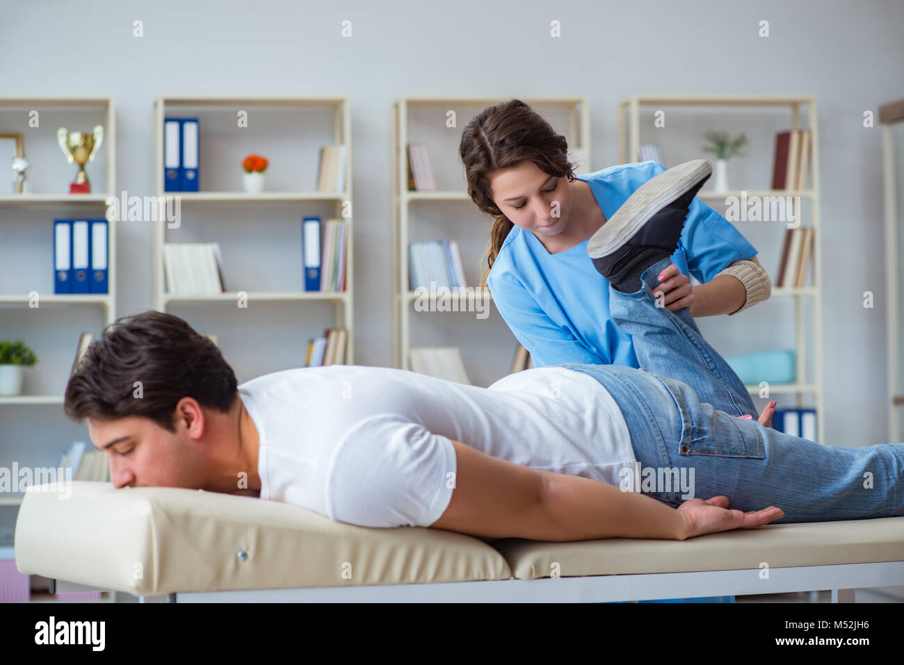 Female chiropractor doctor massaging male patient Stock Photo - Alamy