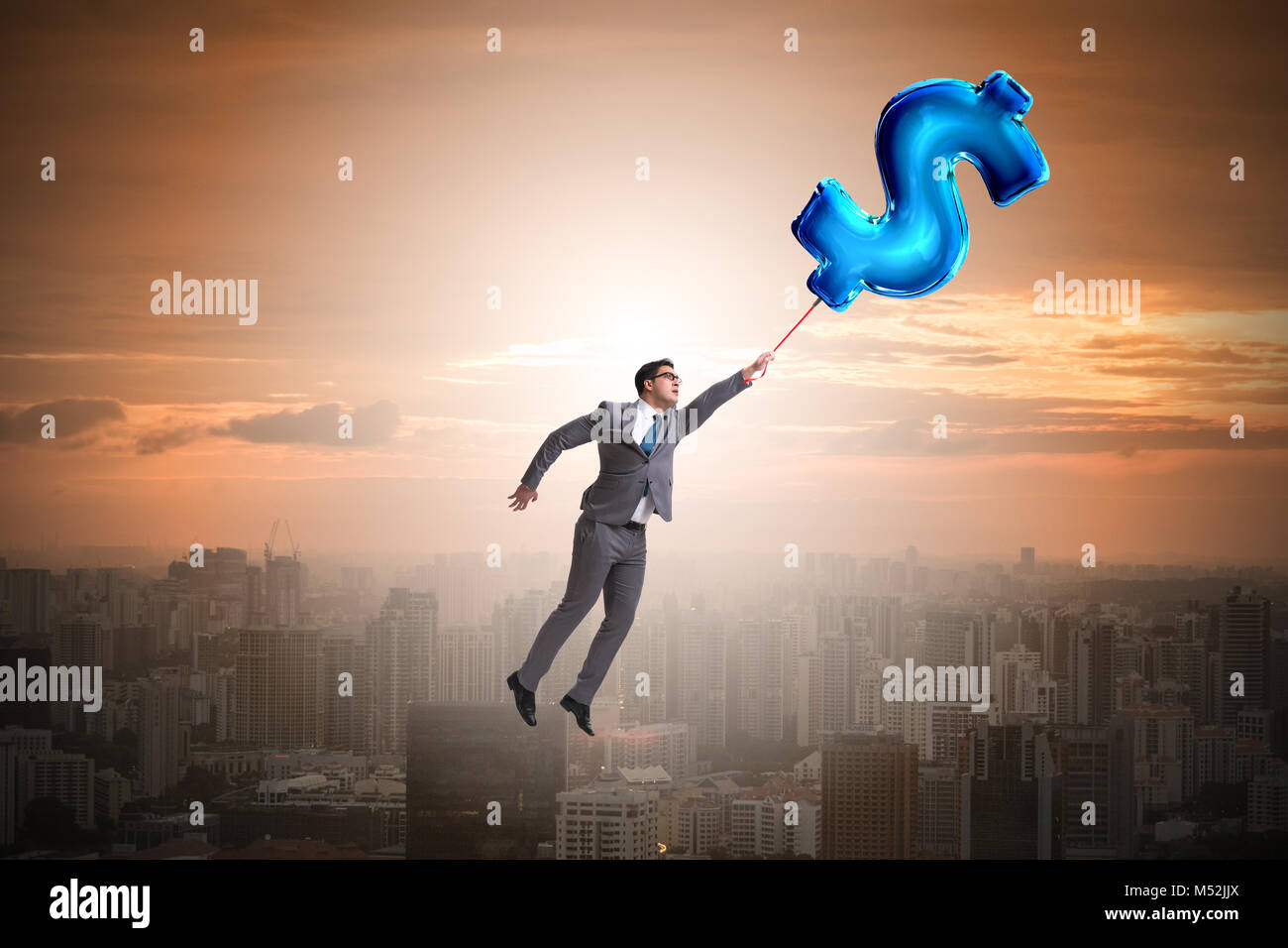 Businessman flying on dollar sign inflatable balloon Stock Photo - Alamy