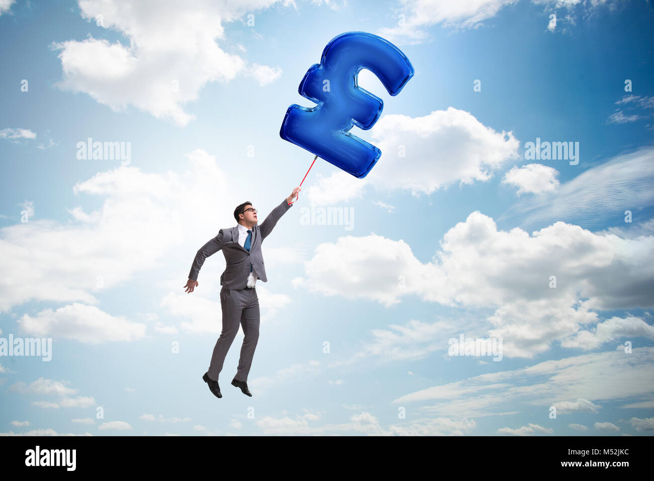 Businessman flying on british pound sign inflatable balloon Stock Photo ...