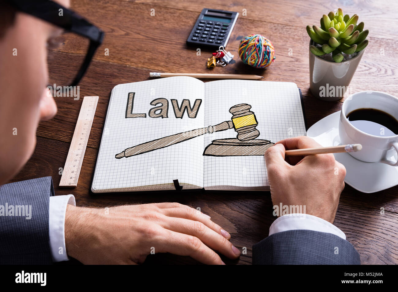 Close-up Of Lawyer Drawing Law Concept In Book With Coffee At Desk ...