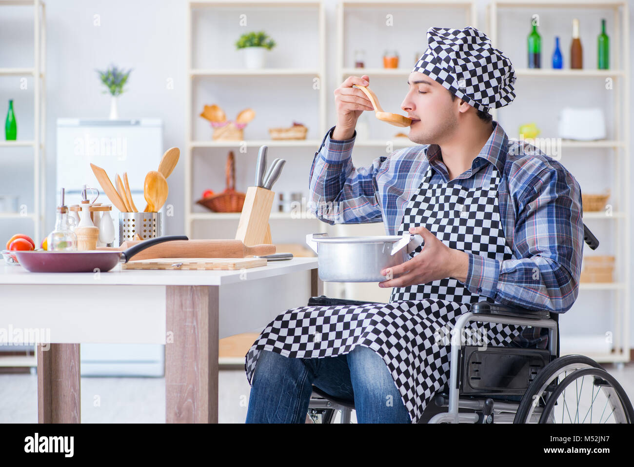 Disabled man preparing soup at kitchen Stock Photo - Alamy