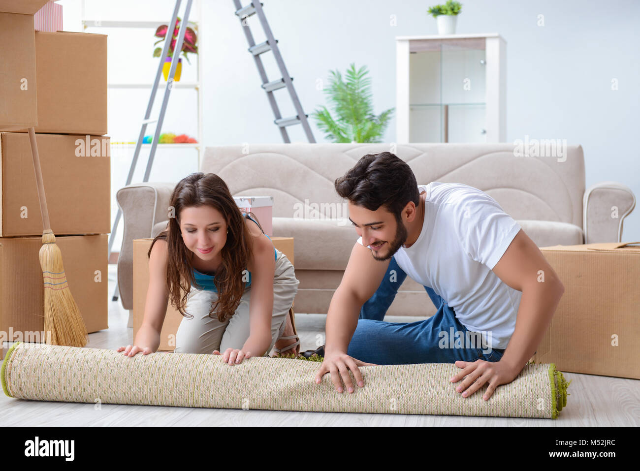 Young family unpacking at new house with boxes Stock Photo - Alamy