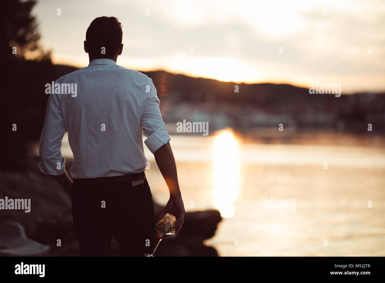 Young stressed business man drinking wine alone.Alcoholic man unhappy ...