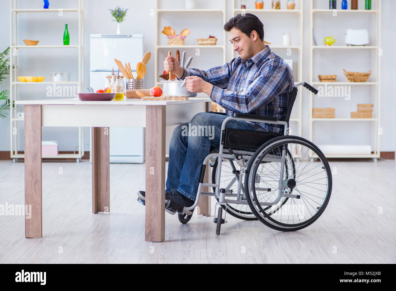 Disabled man preparing soup at kitchen Stock Photo - Alamy