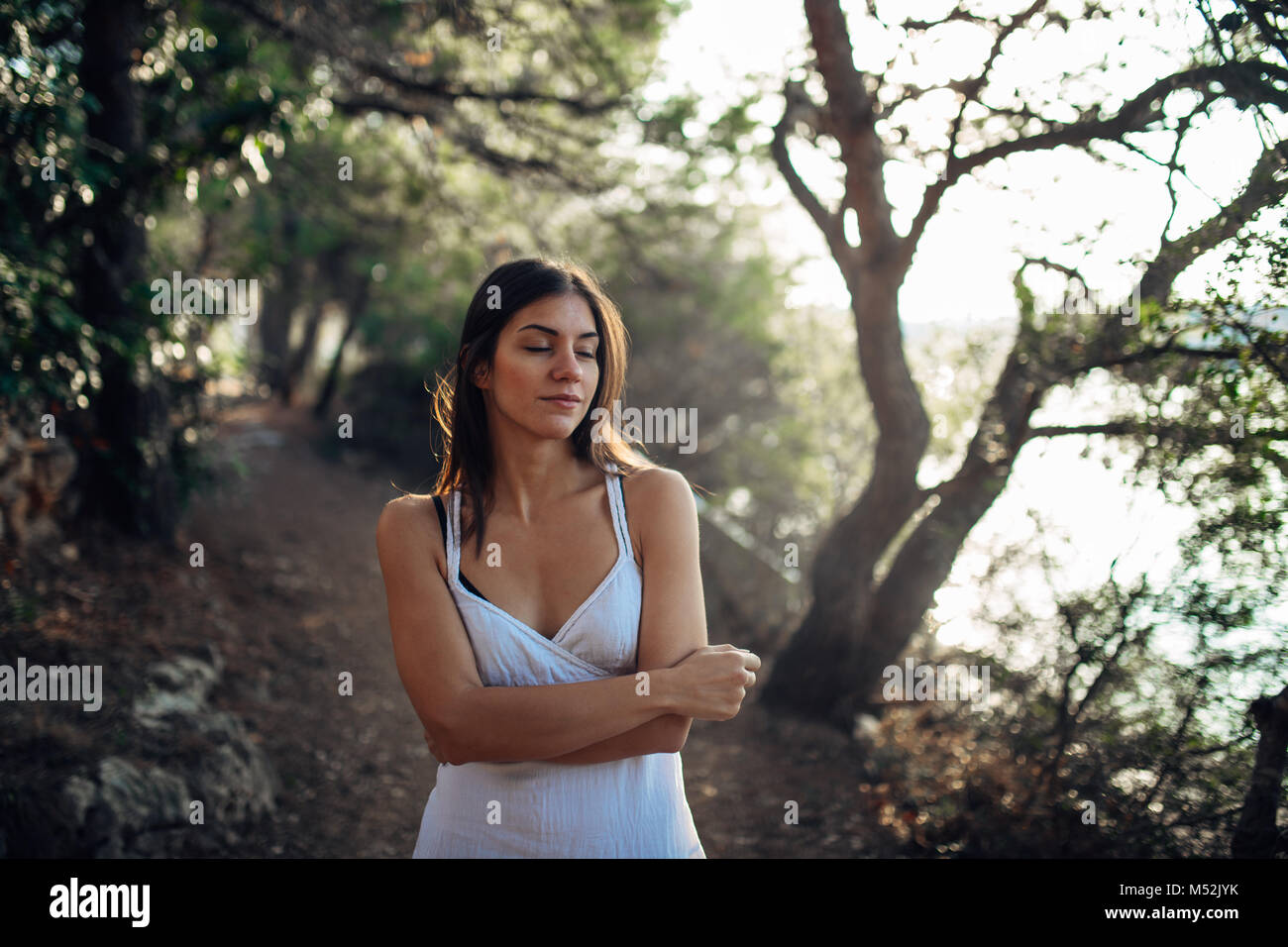 Romantic woman enjoying a walk in nature on a sunny morning.Mindful ...
