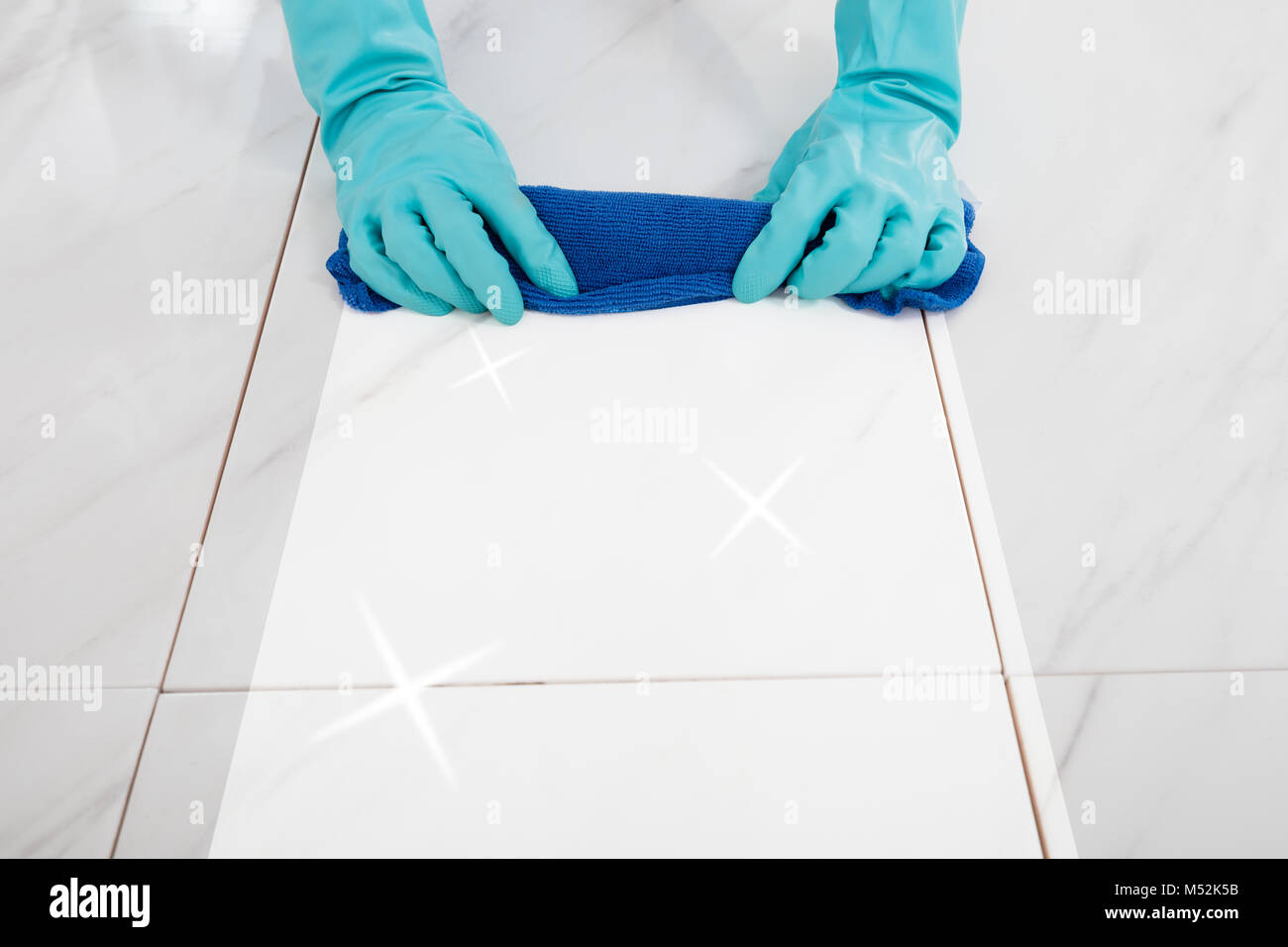 Close-up Of Person's Hand In Glove Sweeping Floor With Rag Stock Photo ...