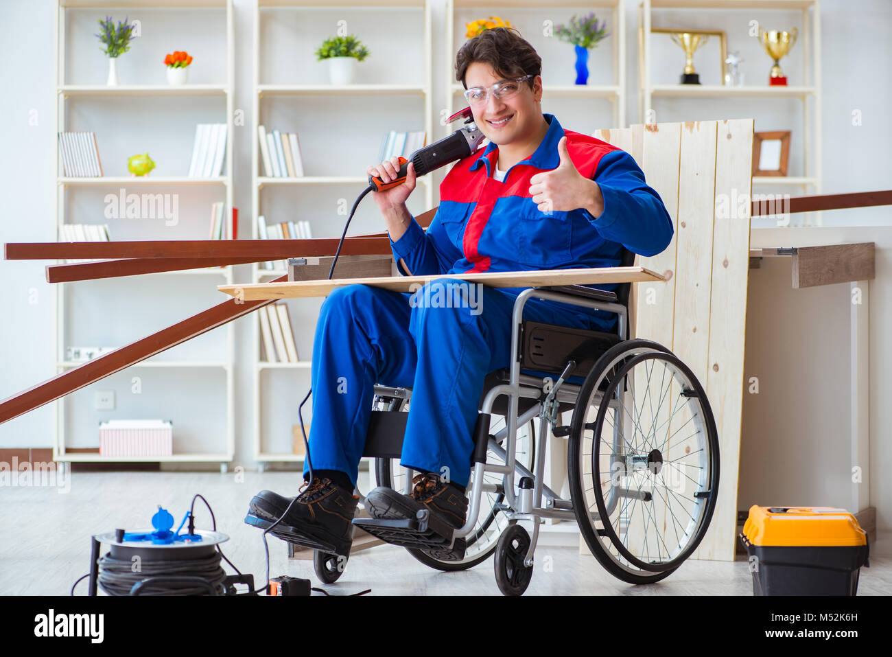Disabled carpenter working with tools in workshop Stock Photo - Alamy