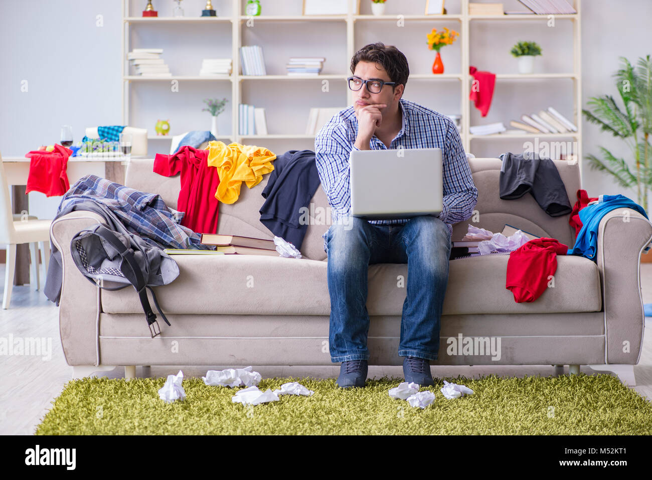 Young man working studying in messy room Stock Photo - Alamy
