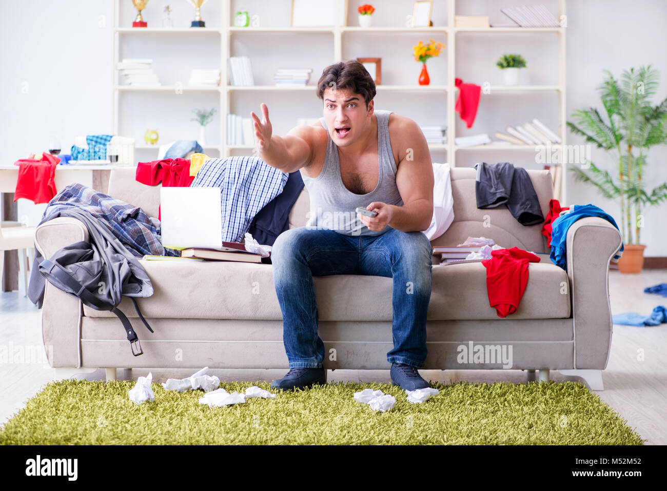 Young man working studying in messy room Stock Photo - Alamy