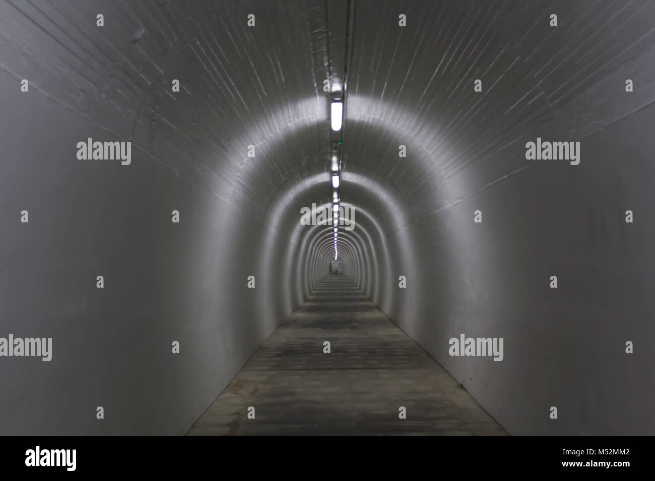 Long white pedestrian tunnel Stock Photo - Alamy