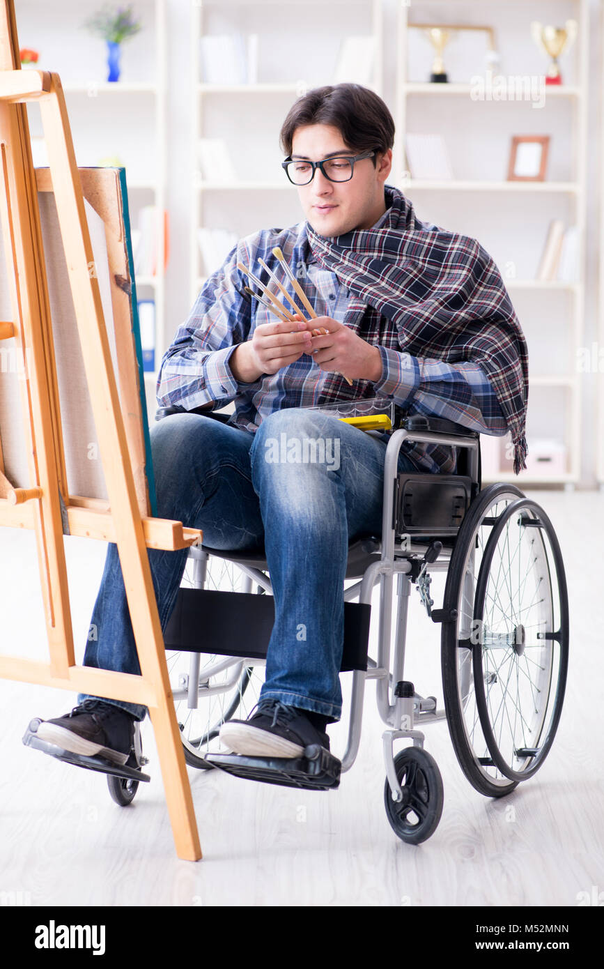 Disabled artist painting picture in studio Stock Photo - Alamy