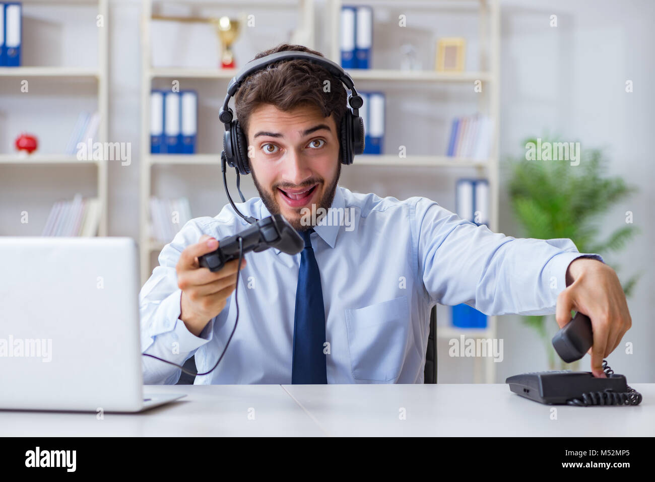 Businessman gamer in office playing games Stock Photo - Alamy