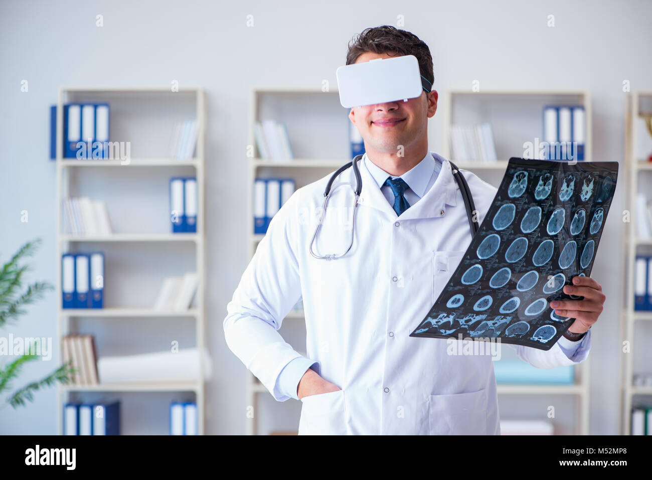 Young doctor looking at MRI scan through VR glasses Stock Photo - Alamy